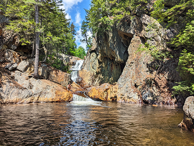 Smalls Falls creates a hidden oasis where tumbling waters have carved intimate pools among moss-covered rocks and evergreen sentinels.