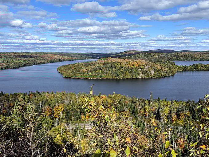 Superior National Forest stretches to the horizon in a tapestry of green, where lakes peek through the canopy like scattered blue gems.