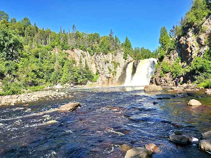 High Falls at Tettegouche creates a magnificent display as water crashes down through a forest setting.