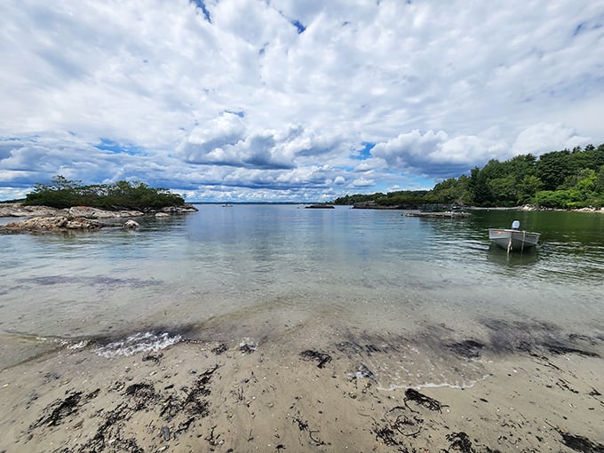 The island's peaceful coves and inlets create perfect natural harbors where small boats rest on tranquil waters.