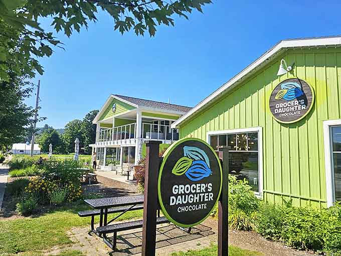 The bright green Grocer's Daughter building with its distinctive cocoa pod logo promises chocolate adventures with a conscience. Ethical sourcing never tasted so good!