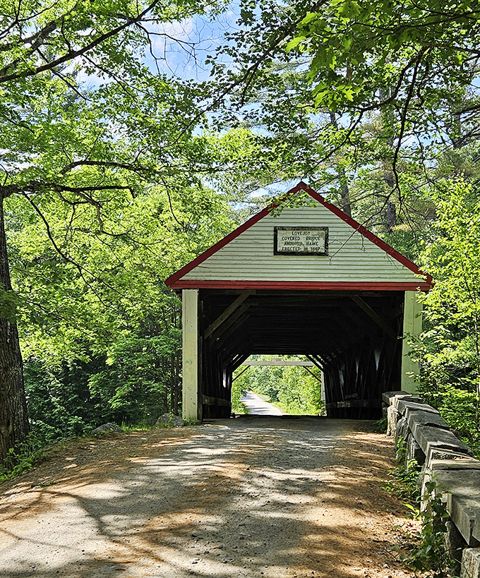 Sunlight streams through Lovejoy Bridge's entrance, illuminating the wooden passage that has welcomed travelers for generations.