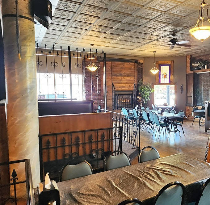 Inside Pizza Pub, vintage tin ceilings and wrought iron railings create a warm, nostalgic atmosphere perfect for enjoying classic pizzas.