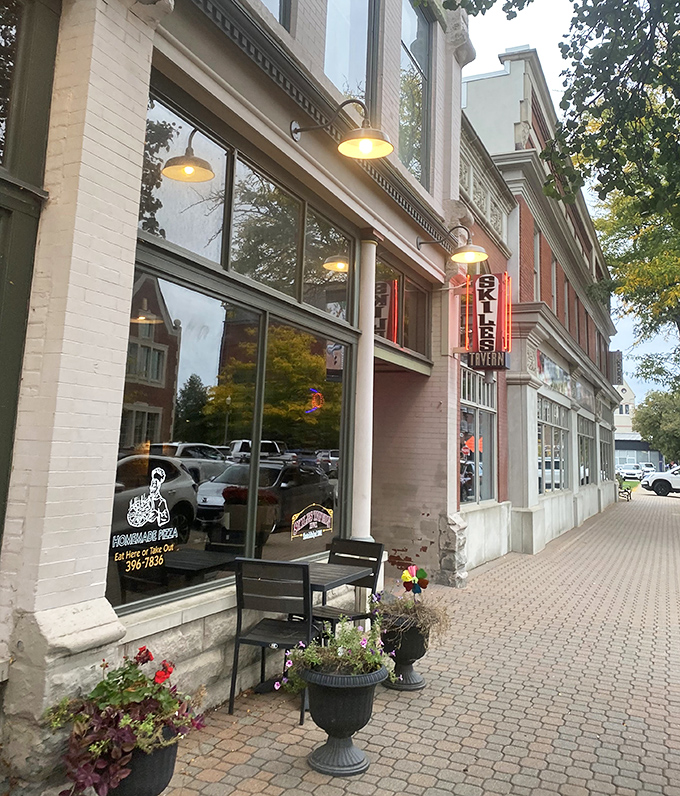 Skiles Tavern's charming storefront with flower planters adds to downtown Holland's picturesque appeal, promising comfort food and local flavor inside.