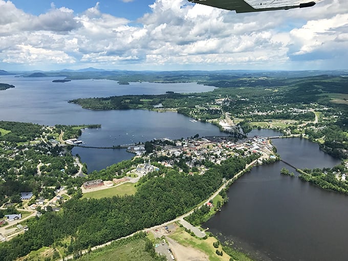 Aerial magic reveals Memphremagog's true grandeur, with Newport nestled between forest and water in nature's perfect embrace.
