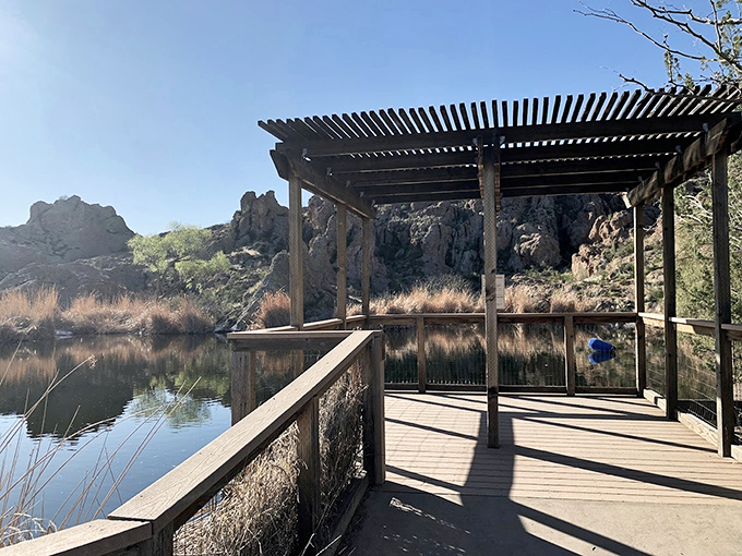 A shaded viewing deck offers the perfect spot to contemplate the serene waters and surrounding desert landscape.