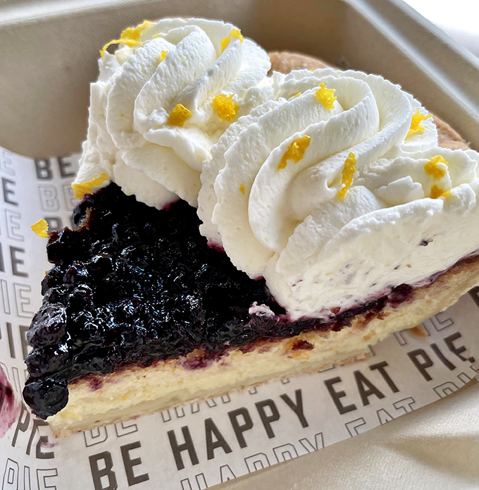 Bursting berries beneath a cloud of whipped cream. Summer captured in a slice, regardless of the season.