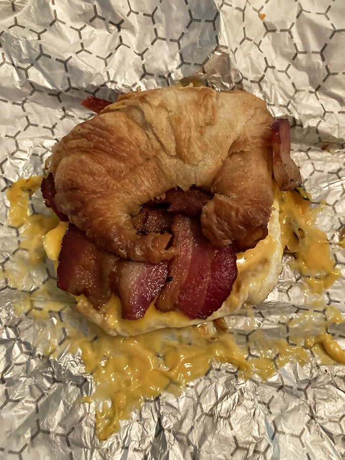 Breakfast nirvana: a golden croissant embracing eggs, bacon and cheese that makes hitting the snooze button seem like a criminal offense.