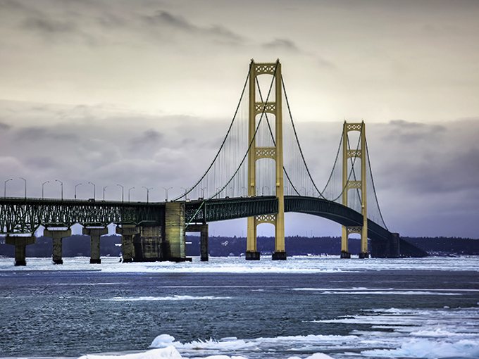 Winter transforms the Mackinac into a bridge between seasons, its stoic span continuing to connect Michigan's peninsulas even as ice claims the straits below.