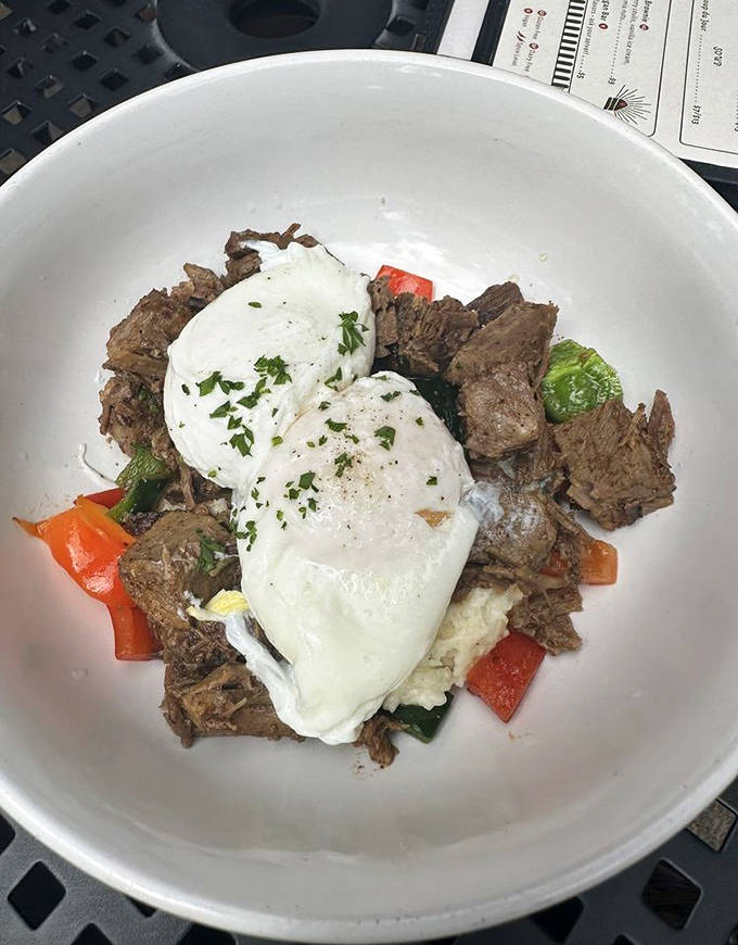 A bowl of brisket and grits topped with a perfectly poached egg – comfort food that somehow manages to be both rustic and elegant.
