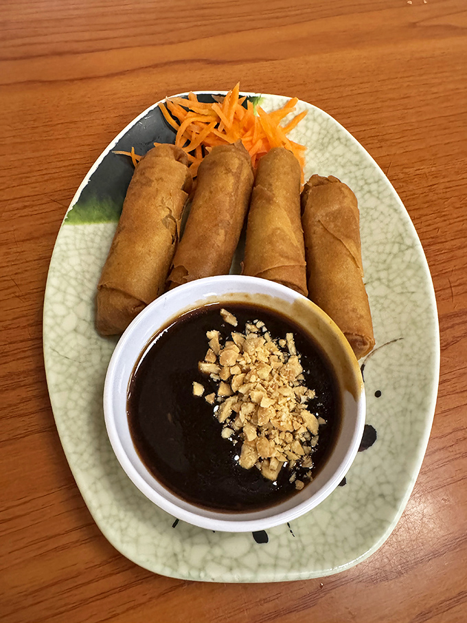Golden-brown egg rolls (Cha Gio) with their crispy rice paper wrappers await a dip in the sweet-salty nuoc cham sauce.