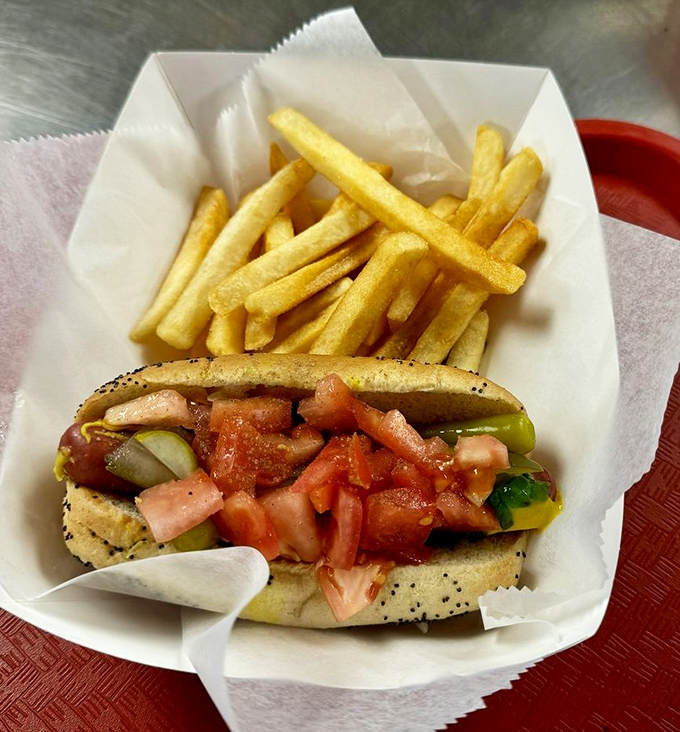 The quintessential Chicago-style dog nestled beside golden fries – a perfect marriage of flavors that's stood the test of time.