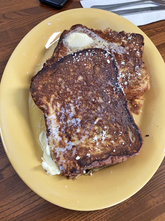 French toast that transforms ordinary bread into something transcendent, dusted with powdered sugar like fresh Maine snow.