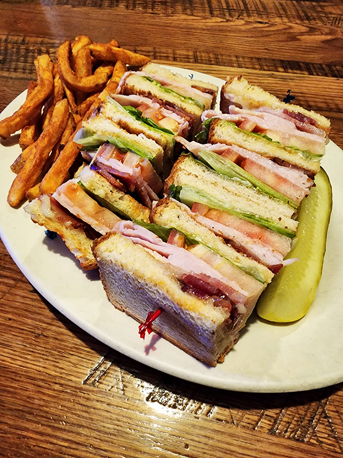 A club sandwich that requires a strategic eating plan – layers of goodness stacked higher than your weekend expectations.