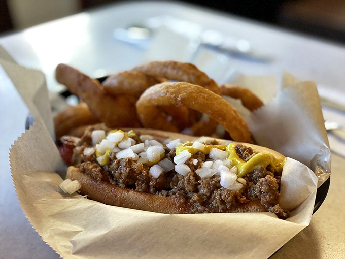 Michigan's beloved Coney tradition lives on&mdash;a snappy dog nestled in a steamed bun, smothered in savory meat sauce with diced onions and mustard.