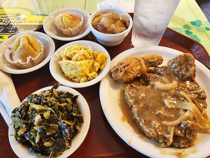 Smothered pork chops with collard greens and mac and cheese prove that Steph's understands the assignment when it comes to soul food.