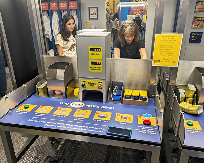 Visitors don hairnets to try their hand at the interactive production line, pressing buttons and experiencing the precision engineering behind each identical can.