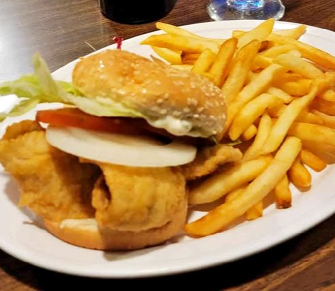 The fish sandwich elevates simple ingredients &ndash; perfectly fried fish, fresh toppings, and golden fries that disappear one "last one" at a time.