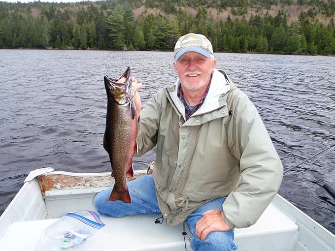 The smile says it all: A proud angler displays his trophy catch from Nahmakanta's cold, clean depths.