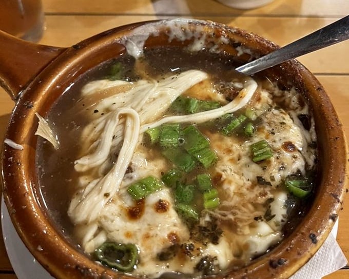 French onion soup that's worth the cheese pull photo op. The broth has clearly been simmering since breakfast, developing flavors that can't be rushed.