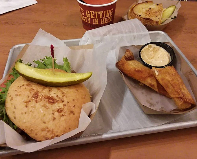 A hearty sandwich shares the spotlight with golden-fried pickle spears and dipping sauce &ndash; a trio that defines the Toasted Pickle experience.