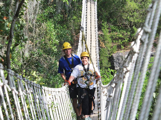 Crossing the swaying sky bridge gives adventurers a treetop perspective of the canyon, testing courage with every step forward.