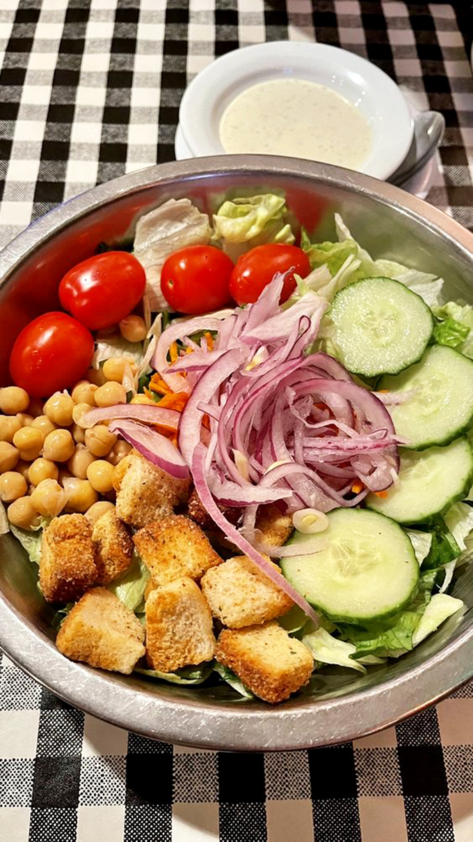 A salad at a pizza joint? Yes, because even vegetables deserve their moment in the spotlight before the main event arrives.