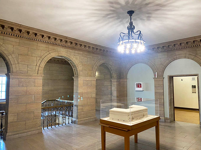 Elegant arches frame the view between reading rooms, where marble columns stand like sentinels guarding centuries of collected wisdom.