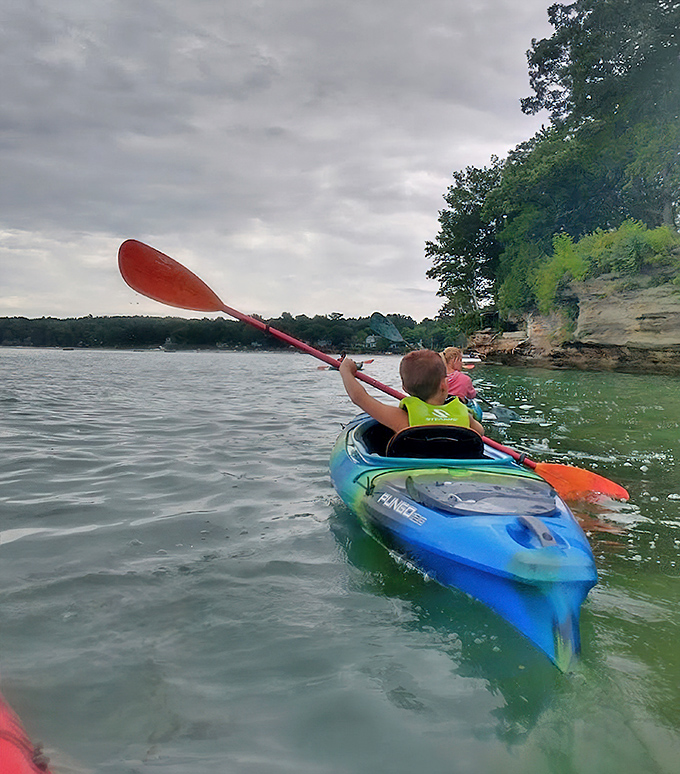 The journey itself becomes part of the adventure as kayakers navigate Lake Huron's shoreline, anticipation building with each paddle stroke.
