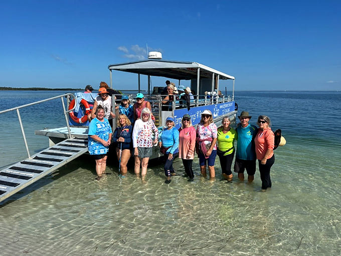 Happy shellers pose with their vessel, proof that multi-generational adventures on Florida's waters create memories that span the ages.