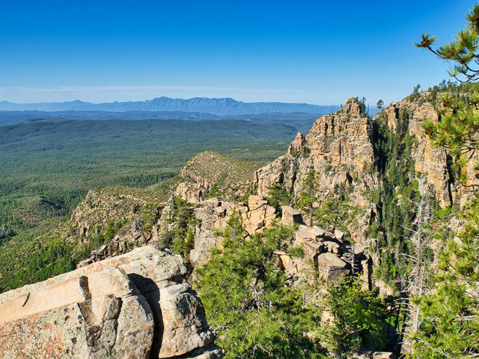 Rugged rock formations stand sentinel along the rim's edge, sculpted by millions of years of wind, water, and geological drama.