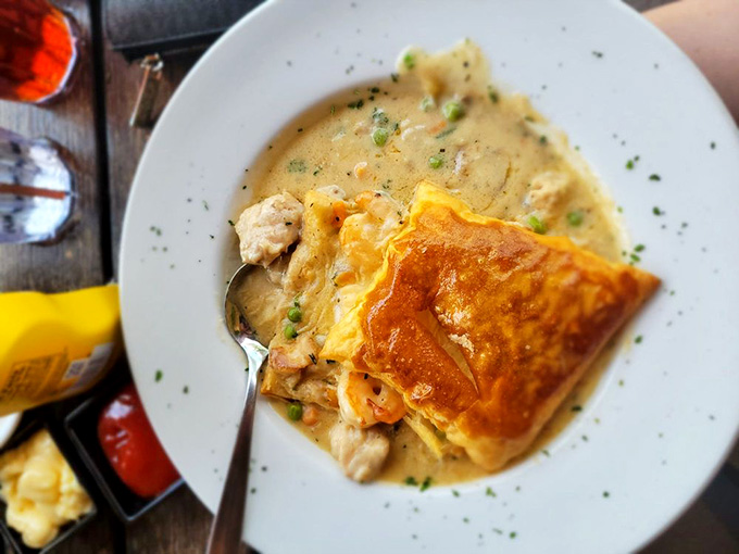 Golden pastry hiding a treasure trove of seafood underneath: this pot pie is what happens when comfort food goes to culinary school.