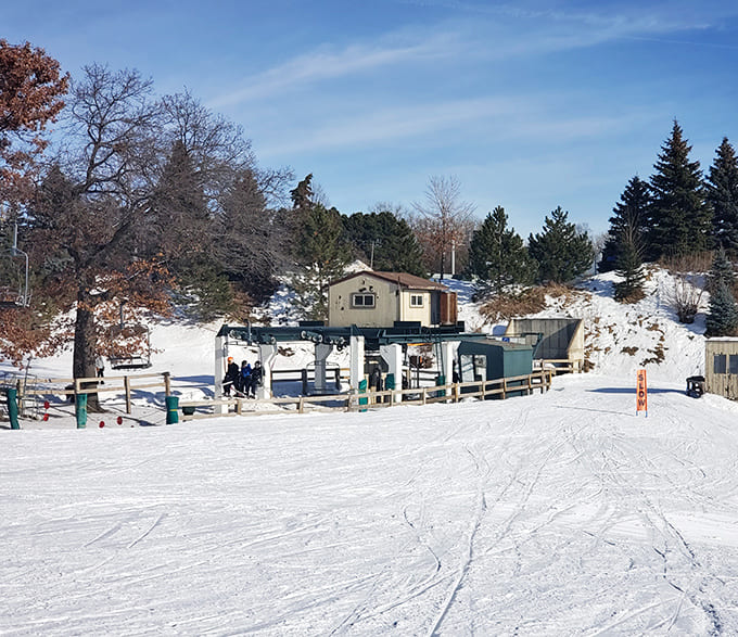 Ski lift terminals dot the landscape, serving the downhill enthusiasts while tubers enjoy their own snowy paradise below.