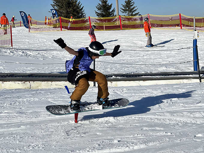 Snowboarder in midair: Defying gravity and common sense simultaneously &ndash; the moment before either Instagram glory or a spectacular wipeout story is born.
