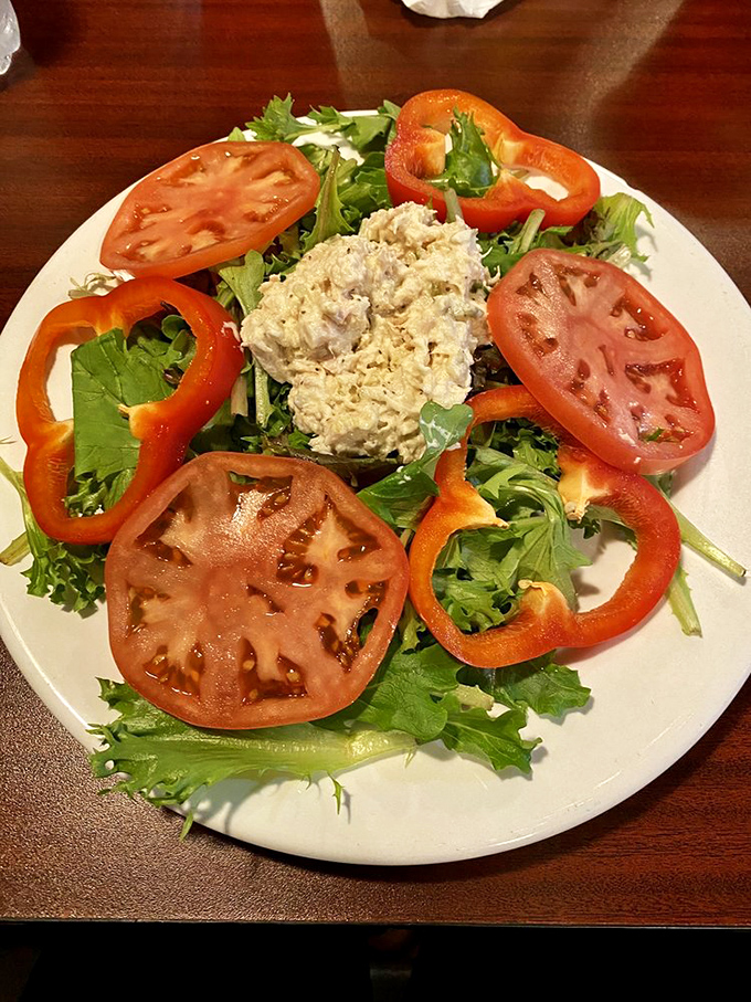Fresh and vibrant, the tuna salad arrives surrounded by a colorful array of tomatoes and greens &ndash; proof that healthy eating needn't be boring.