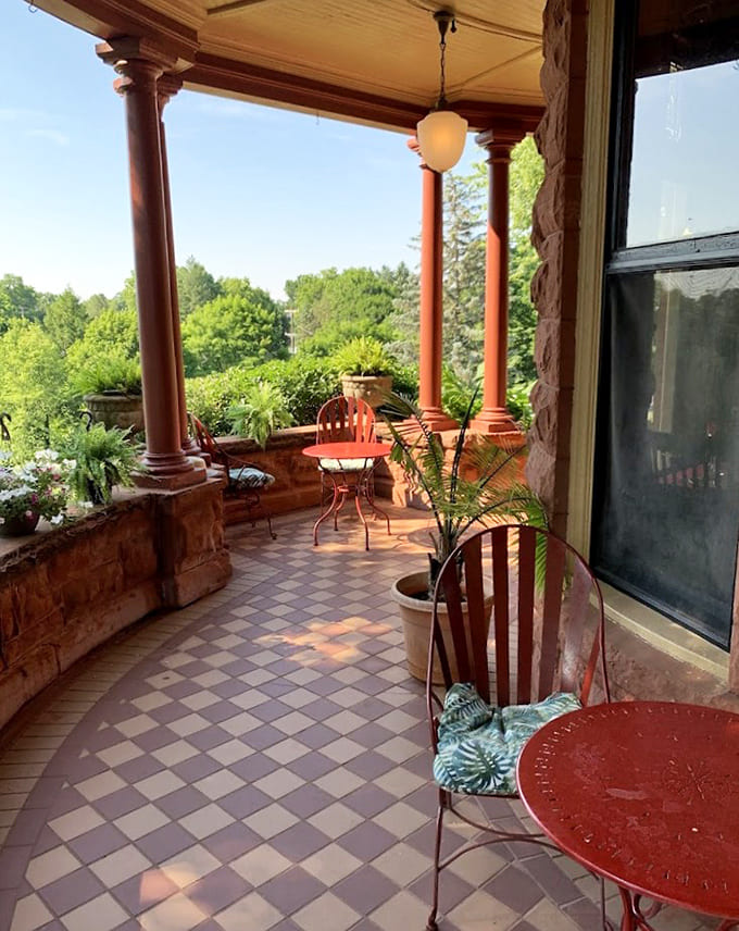 The veranda provides the perfect spot for contemplating mysteries, sipping drinks, or pretending you're wealthy enough to own a castle.