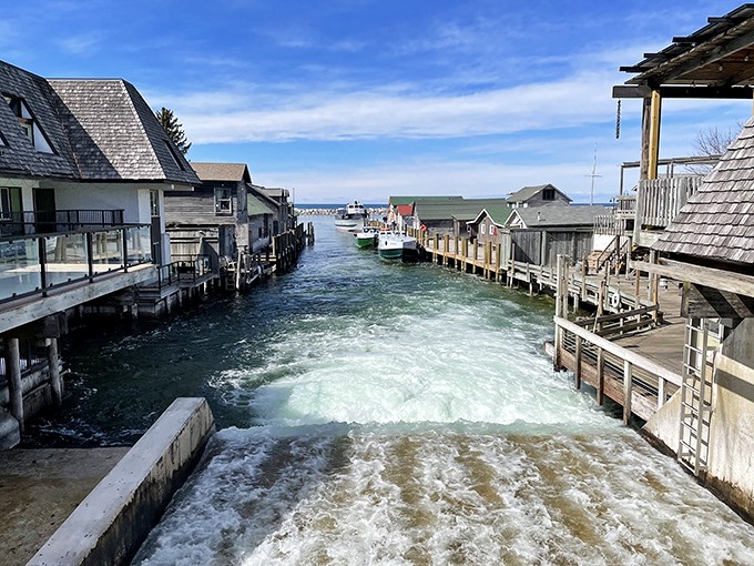 The canal waterway slices through Fishtown like a liquid main street, where boats replace cars and every dock tells a story.