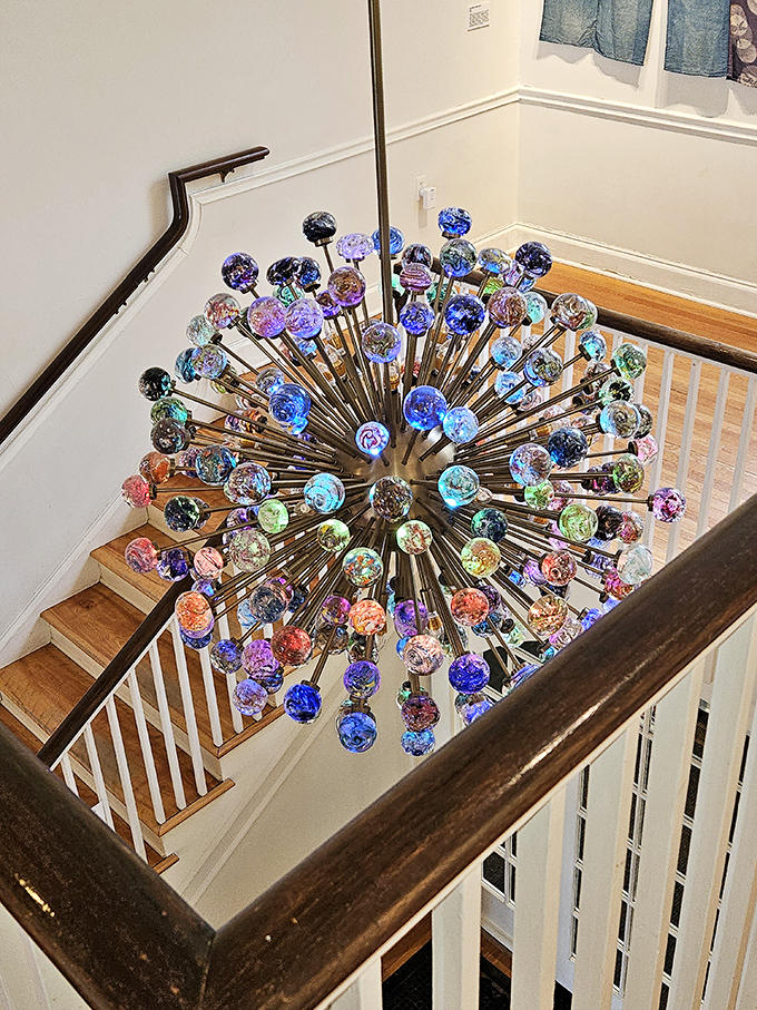 Looking up reveals a spectacular burst of glass globes, like a frozen firework suspended in mid-explosion above the staircase.