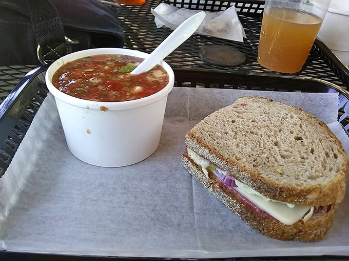 The ultimate power couple: a hearty sandwich with a side of homemade soup, served on simple black trays with zero pretension.