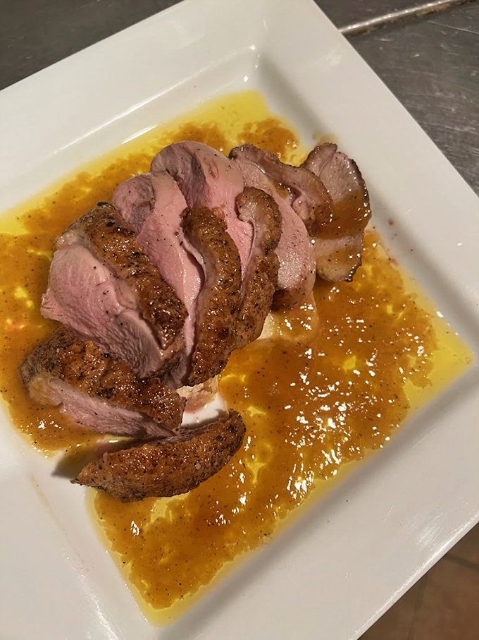 Duck breast cooked to pink perfection lounges in a pool of sauce that's hitting all the sweet-savory notes like a culinary jazz quartet.