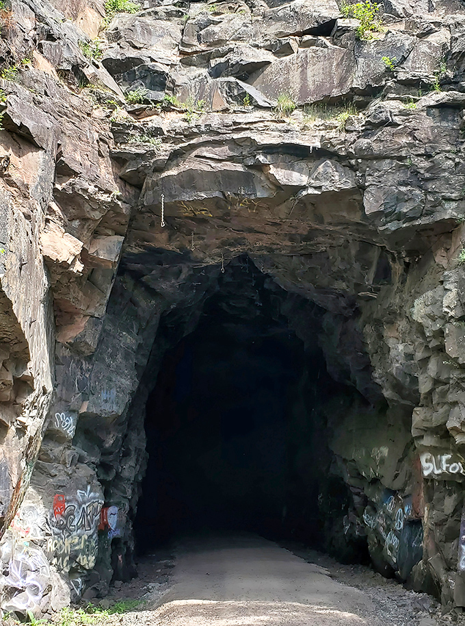Between rock faces: The trail cuts through ancient stone walls, a reminder of the geological forces that shaped this landscape.