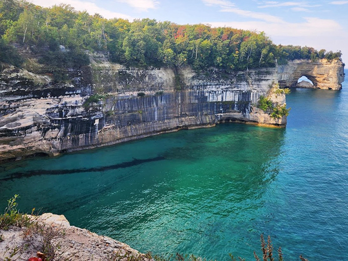The cliff section stretches like nature's own Great Wall, its colorful striations revealing millions of years of Earth's history in one spectacular panoramic view.