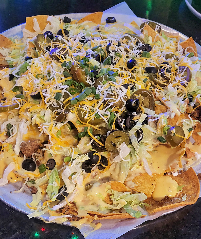 Nachos so loaded they need their own zip code! Black olives and jalapeños stand guard over a landscape of cheese and toppings.