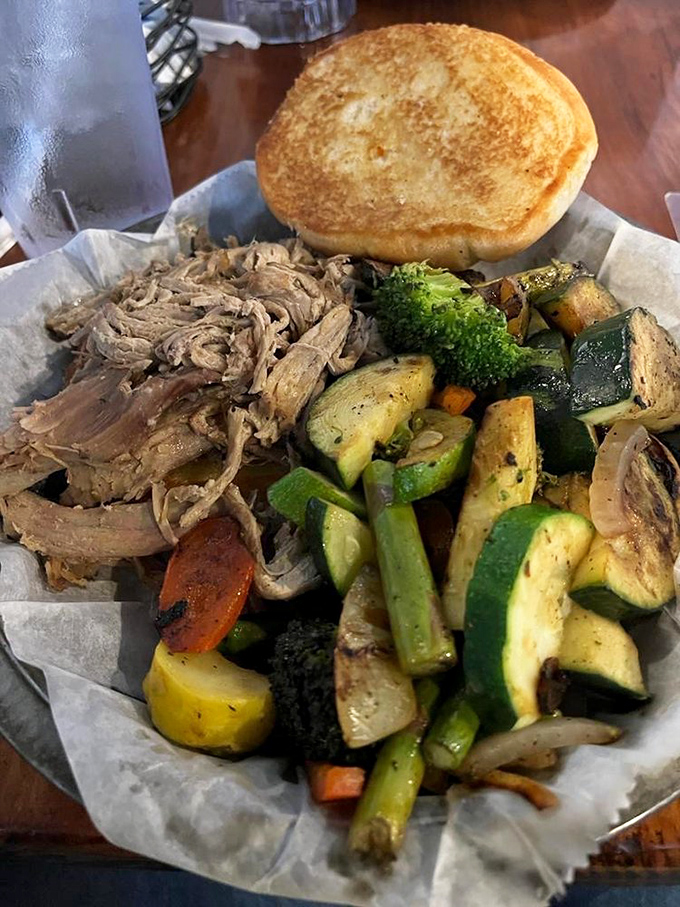 A pulled pork sandwich with garden-fresh vegetables &ndash; proof that balance exists in the barbecue universe.