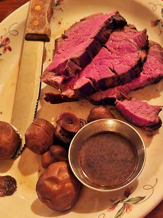 The tenderloin tells a story of perfect preparation – rosy interior, caramelized exterior, and mushrooms that have found their true calling.