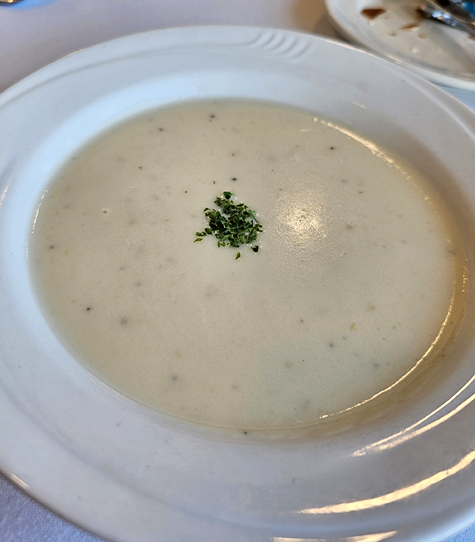 Creamy potato leek soup arrives with a sprinkle of fresh herbs &ndash; comfort food that steadies nerves as suspicions grow among passengers.