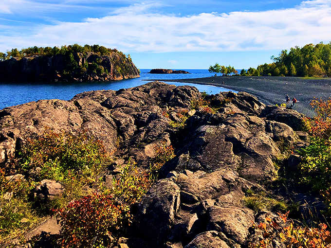 Perfect Minnesota day: sunshine illuminates the dramatic contrast between dark sands and the North Shore's rugged beauty.
