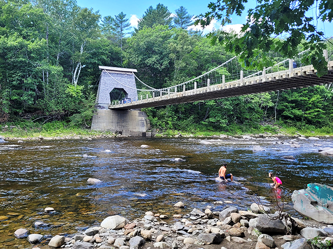 Summer brings locals to cool off in the river's refreshing waters, the bridge providing both shade and a perfect jumping-off point.
