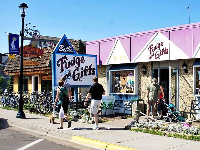 Locals and visitors mingle on sidewalks lined with shops offering everything from handcrafted souvenirs to outdoor essentials.