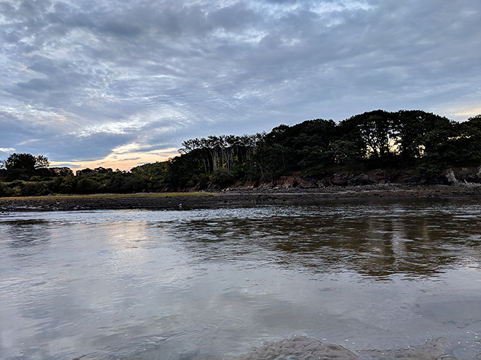 Winter transforms Higgins Beach into a snow-dusted wonderland where coastal cottages glow with warmth against the frosty landscape.